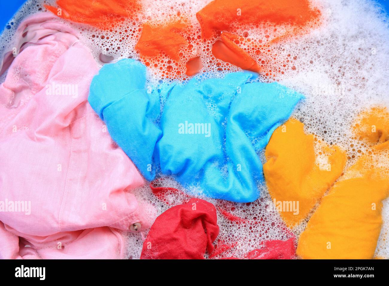 Colorful clothes in suds, top view. Hand washing laundry Stock Photo ...