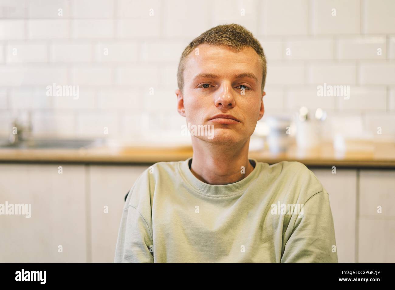 Portrait of young man handicapped with disabilities. Optimistic smiling ...
