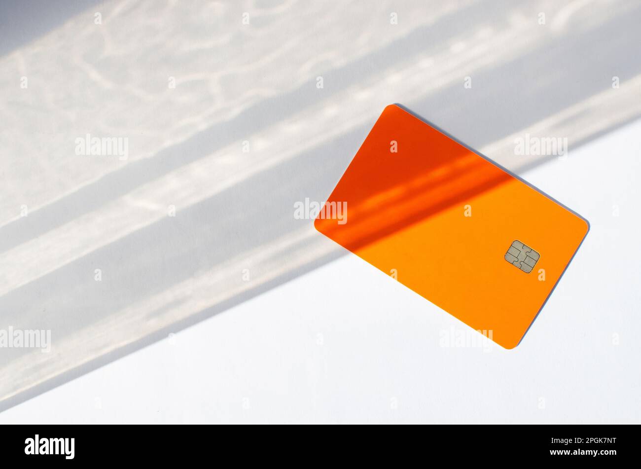 A closeup of an orange credit card isolated on an empty surface Stock ...