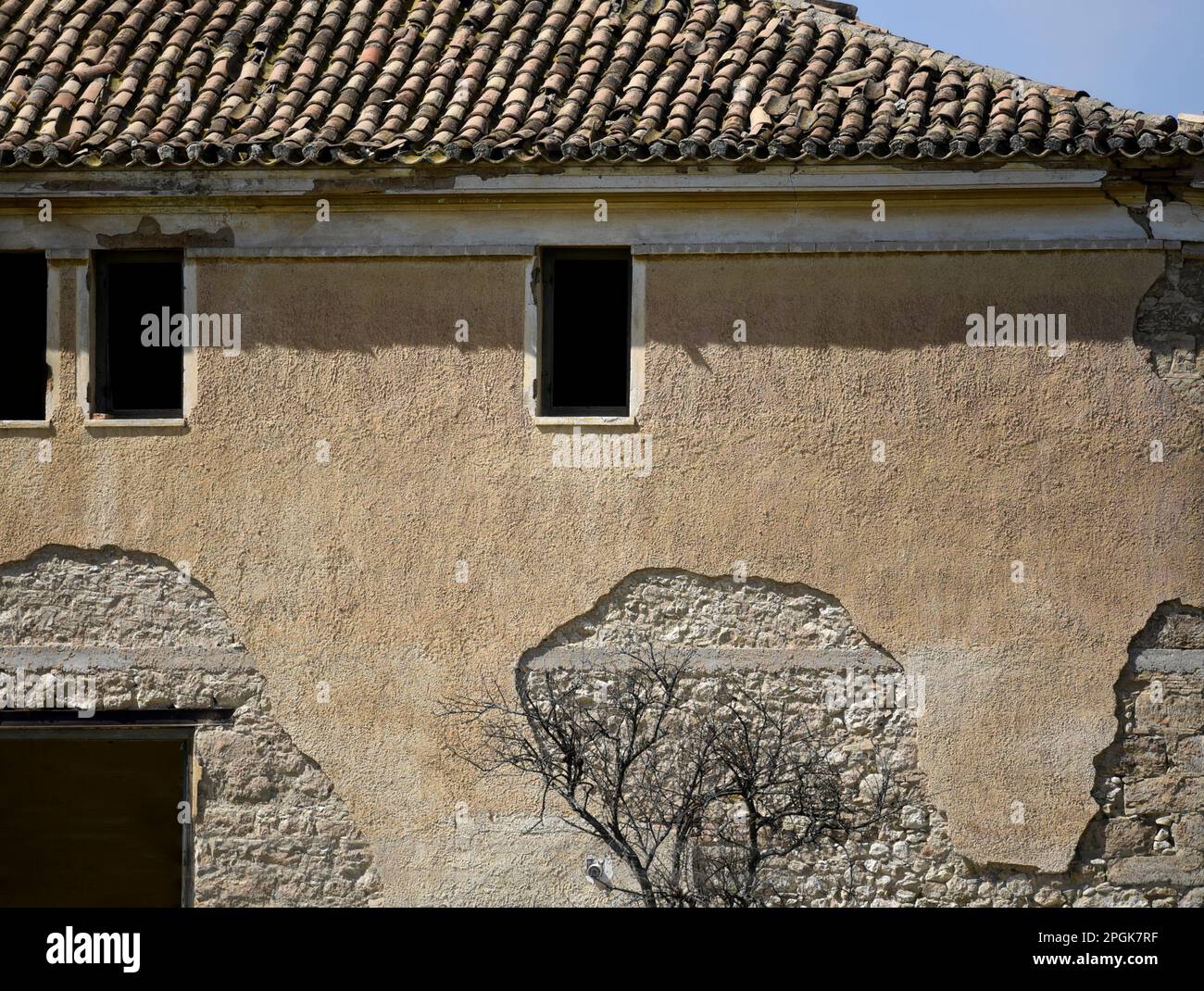 Old abandoned house with an antique clay tile rooftop and weathered ...