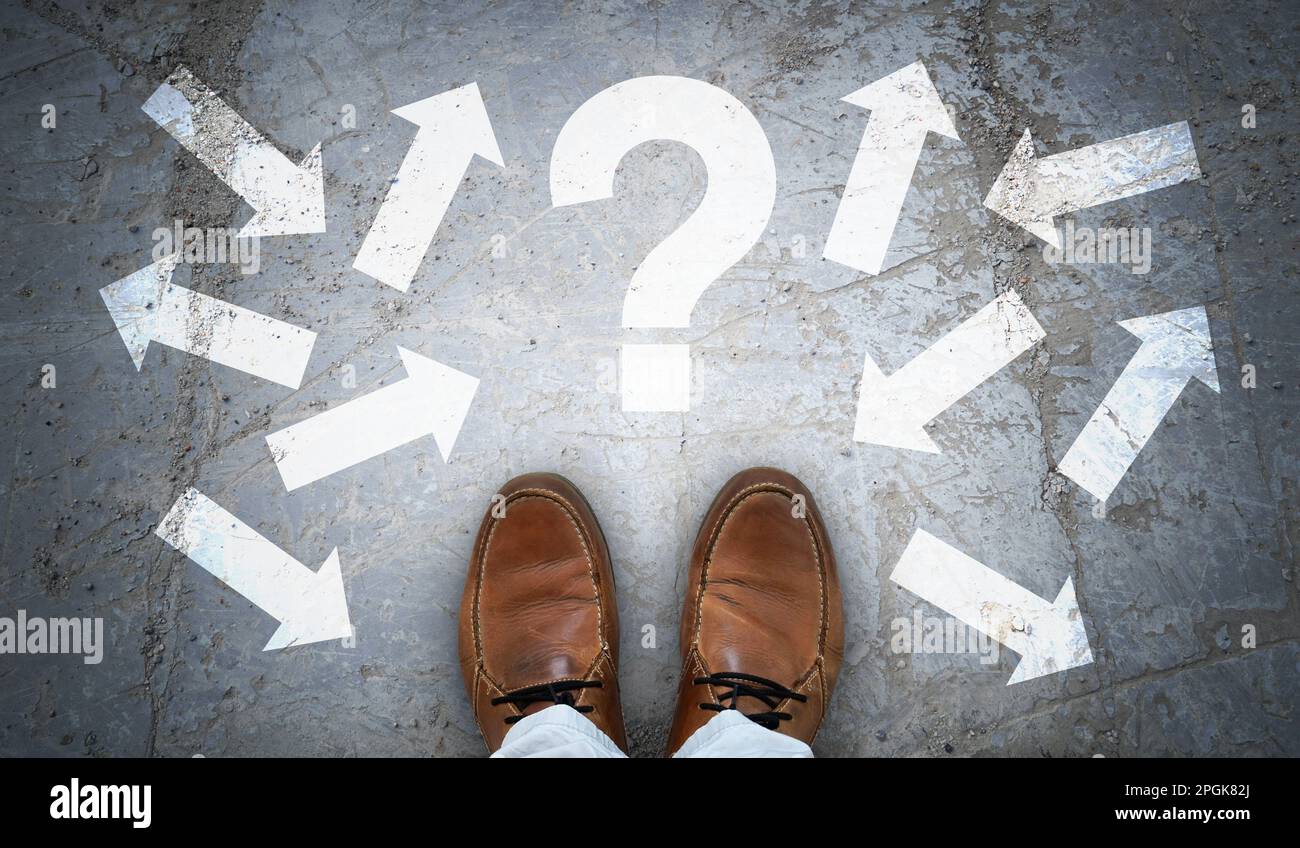 Brown leather shoes, question mark and many arrows - chaos concept ...