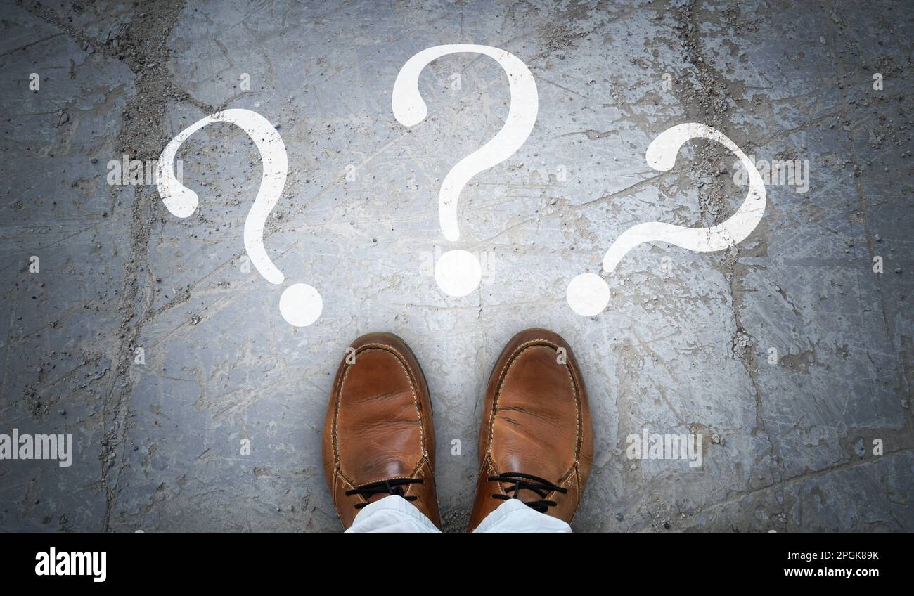 Brown leather shoes and three question marks - problem concept Stock ...