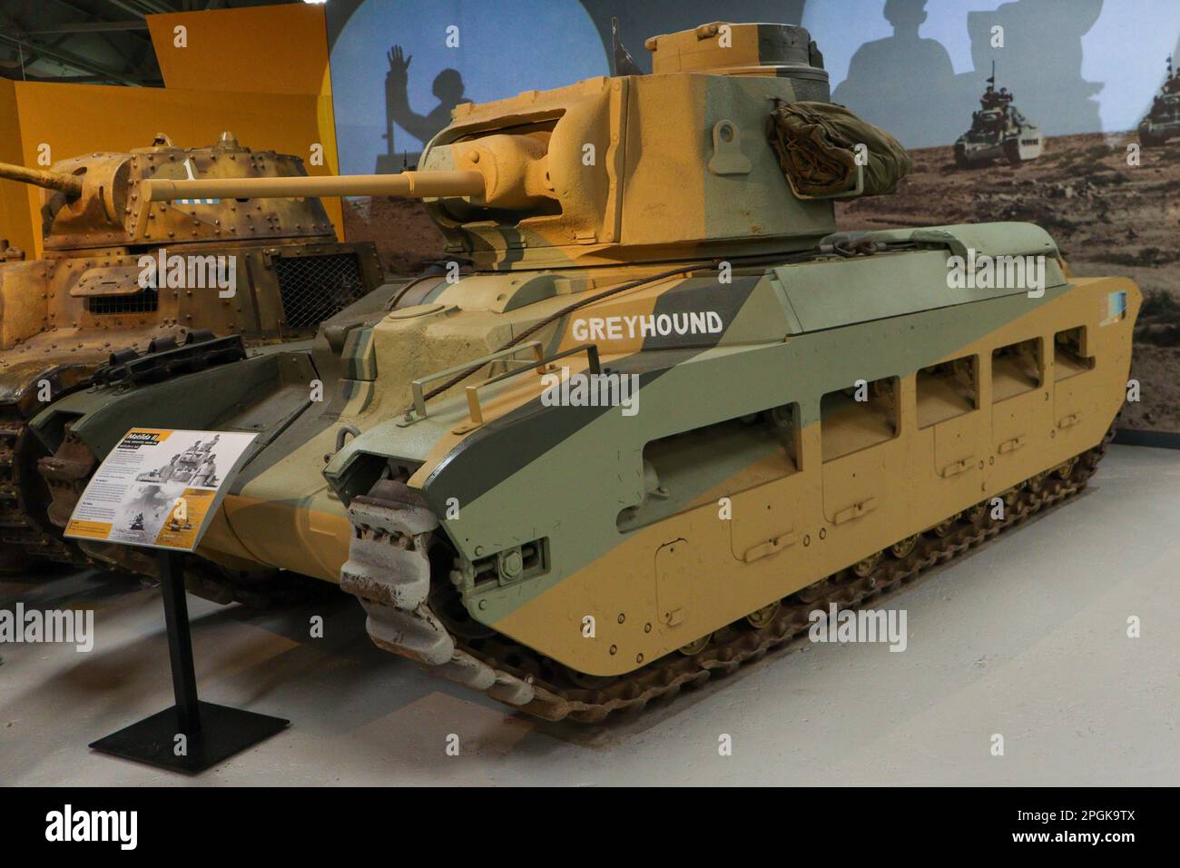 This image depicts a variety of military tanks on display and arranged ...