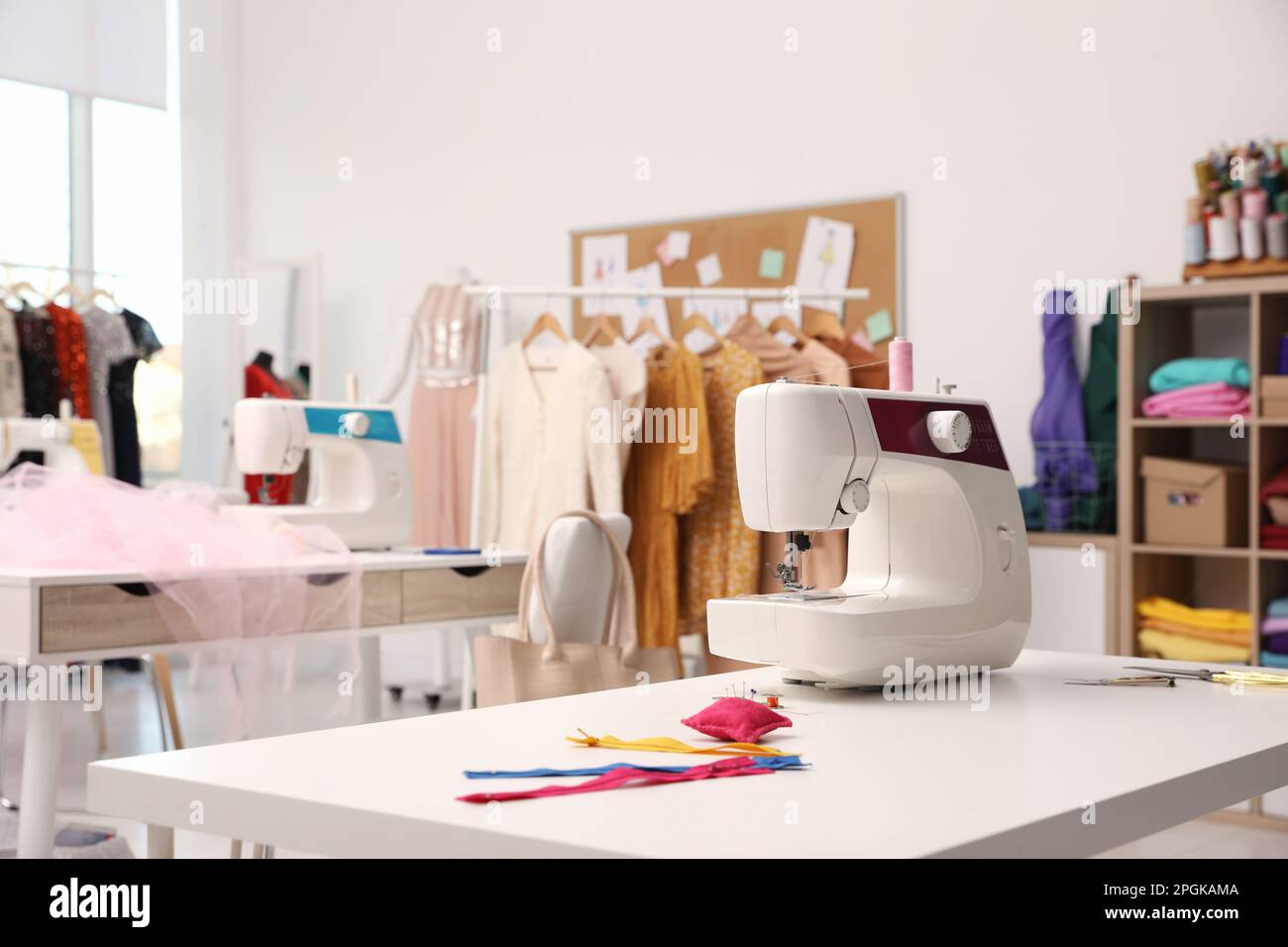 Sewing machine and accessories on table in dressmaking workshop Stock ...