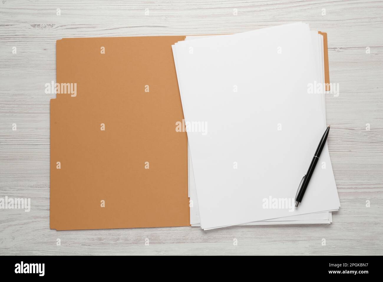Yellow file with blank sheets of paper and pen on white wooden table ...