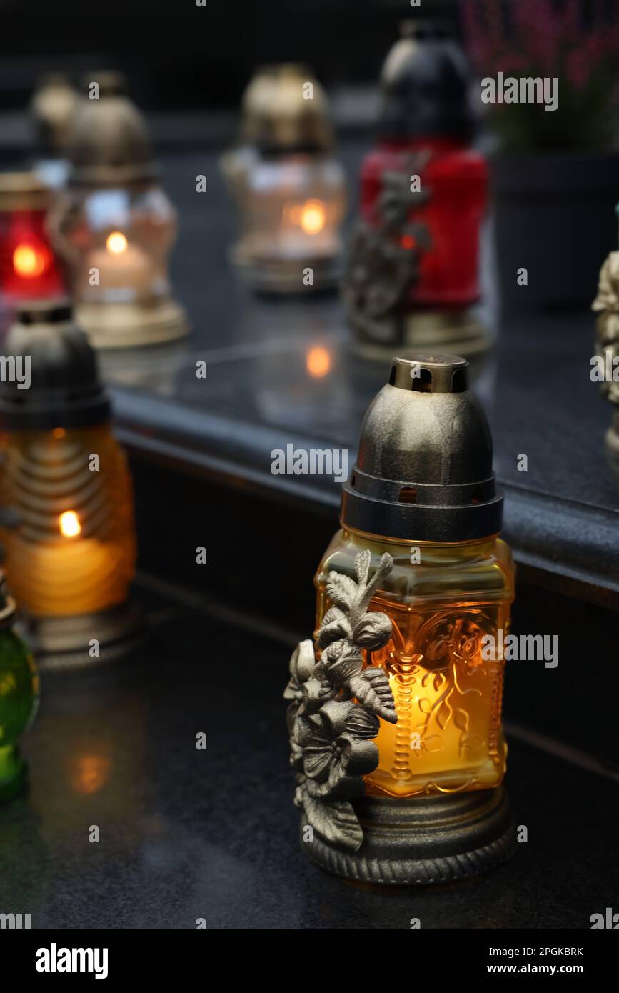 Grave lights on granite surface at cemetery Stock Photo - Alamy