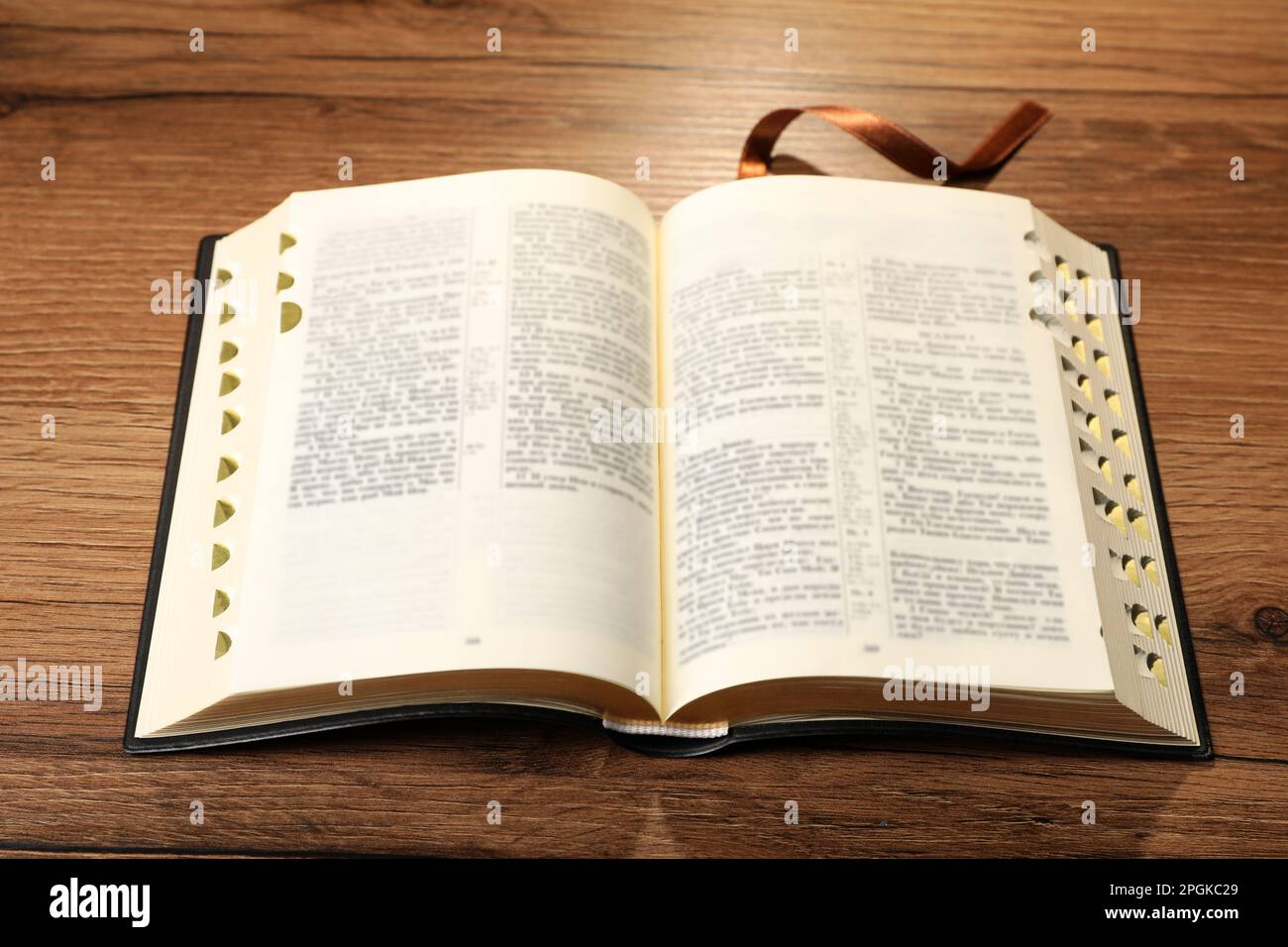 Open Bible on wooden table. Religious literature Stock Photo - Alamy
