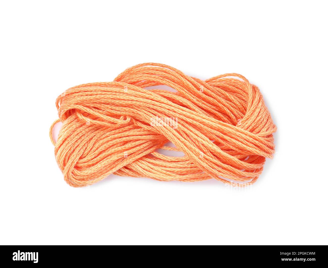 Pale orange embroidery thread on white background Stock Photo - Alamy