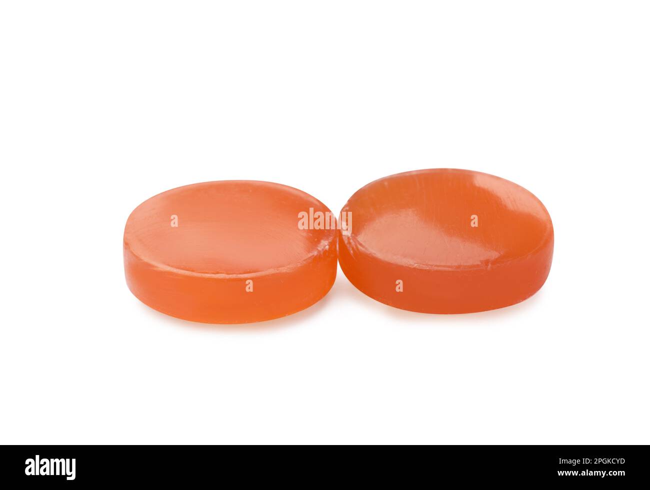 Two orange cough drops on white background Stock Photo - Alamy