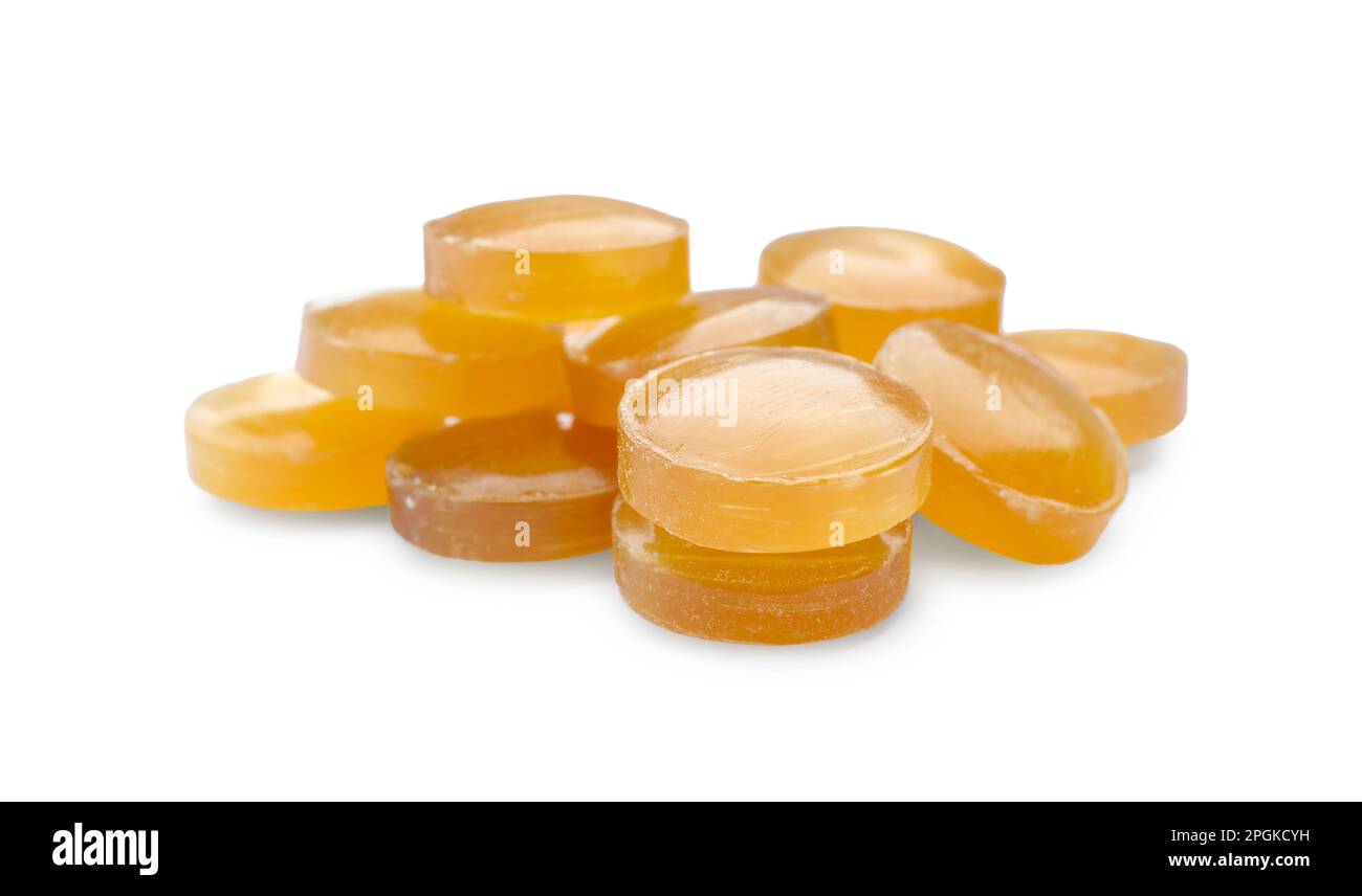Many yellow cough drops on white background Stock Photo - Alamy
