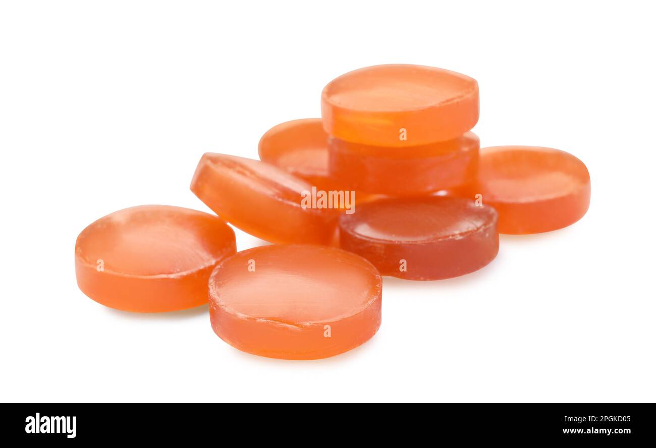 Many orange cough drops on white background Stock Photo - Alamy
