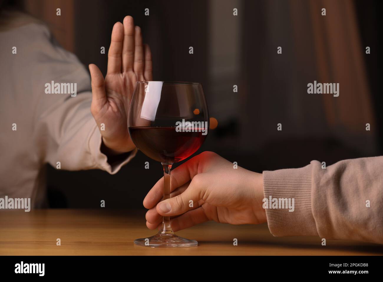Woman refusing to drink red wine indoors, closeup. Alcohol addiction ...