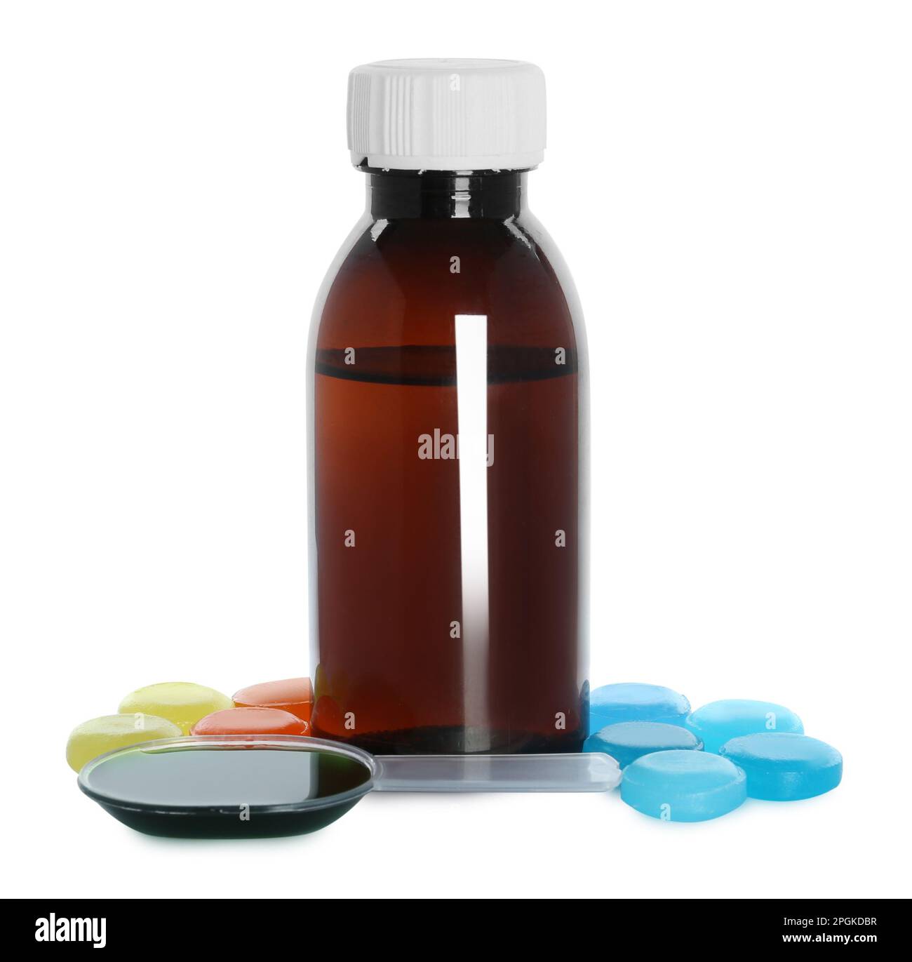 Bottle of syrup, dosing spoon and cough drops on white background Stock ...