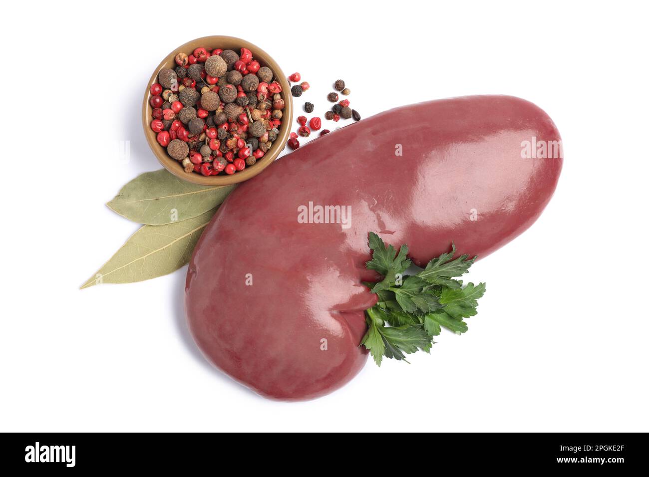 Fresh raw pork kidney with parsley, bay leaves and peppercorns on white ...