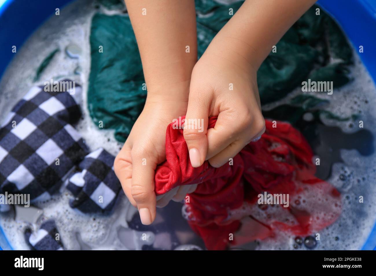 Woman washing clothes in basin hi-res stock photography and images - Alamy