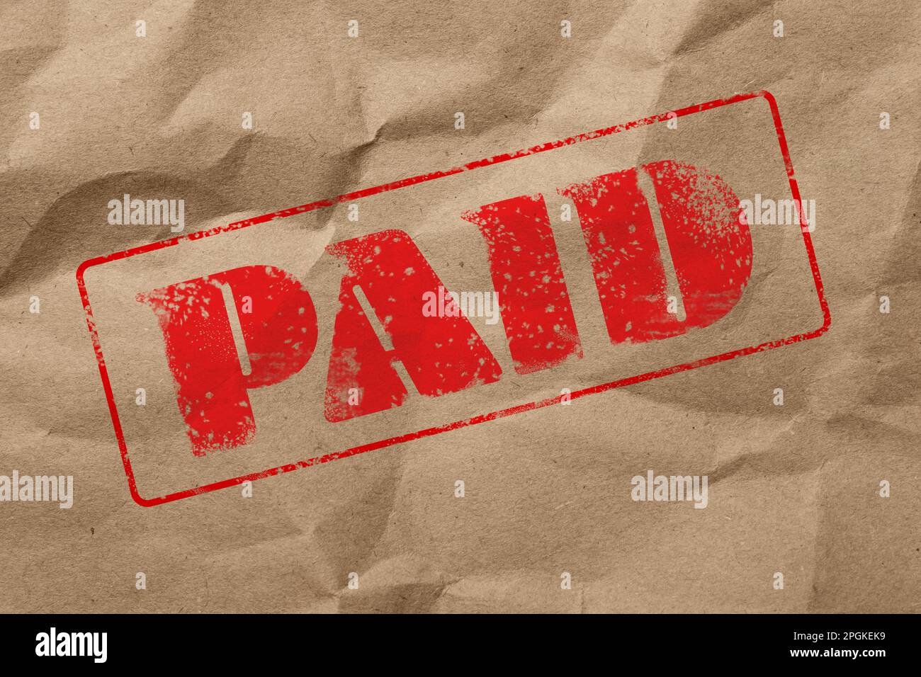 Crumpled kraft paper with stamp PAID, top view Stock Photo - Alamy