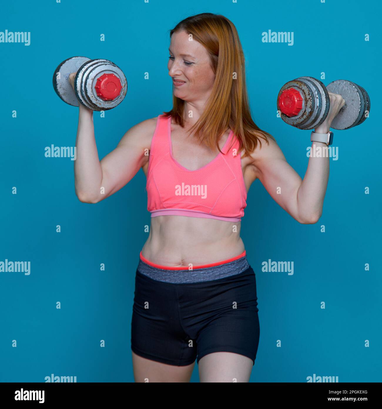 Woman doing triceps exercise dumbbells hi-res stock photography and ...