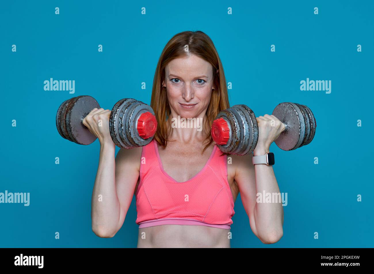 Beautiful strong woman exercises dumbbells hi-res stock photography and ...