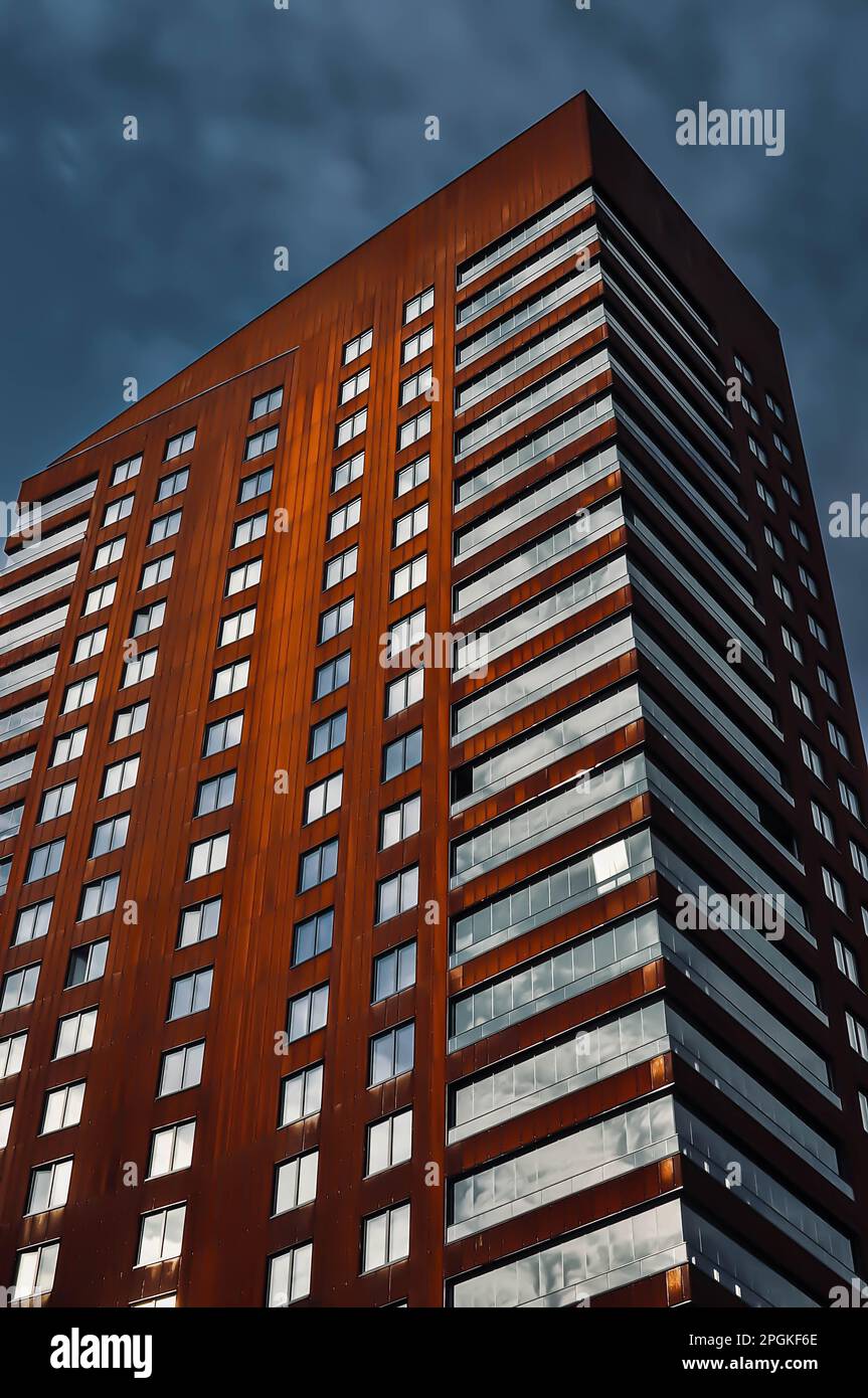 A grand building with a multitude of illuminated windows against a ...