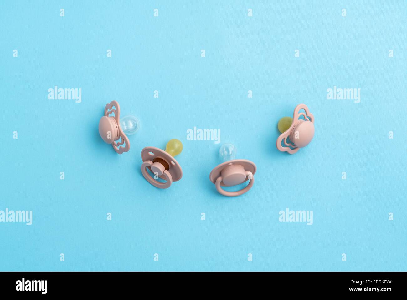 Pacifiers on blue background with copy space, top view of soothers ...