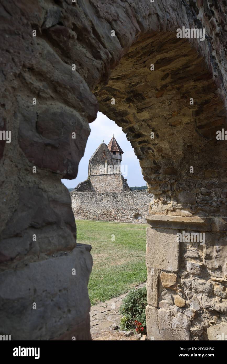 Entrance tower of Cârța Monastery seen through an arch in an old stone ...