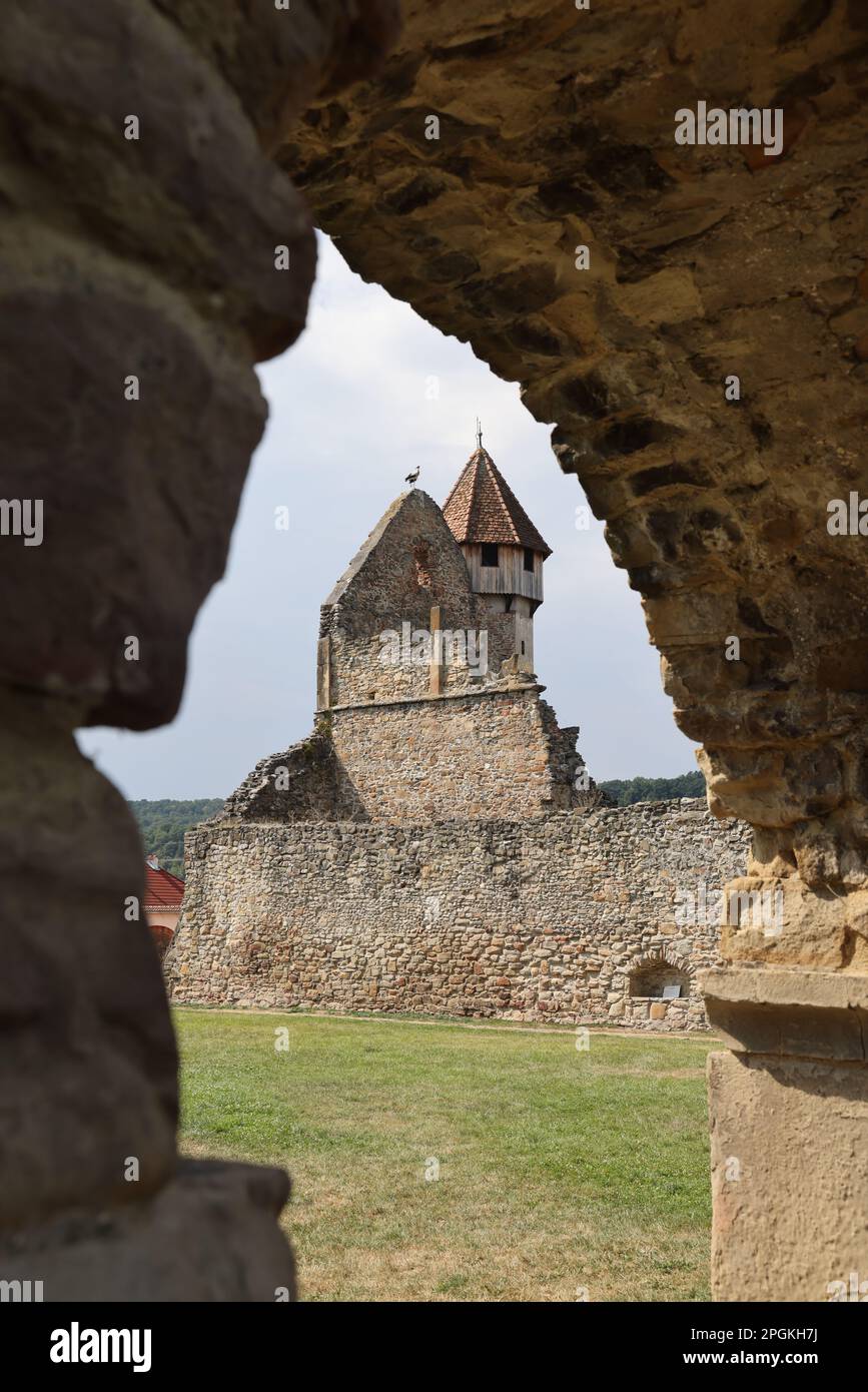 Entrance tower of Cârța Monastery seen through an arch in an old stone ...