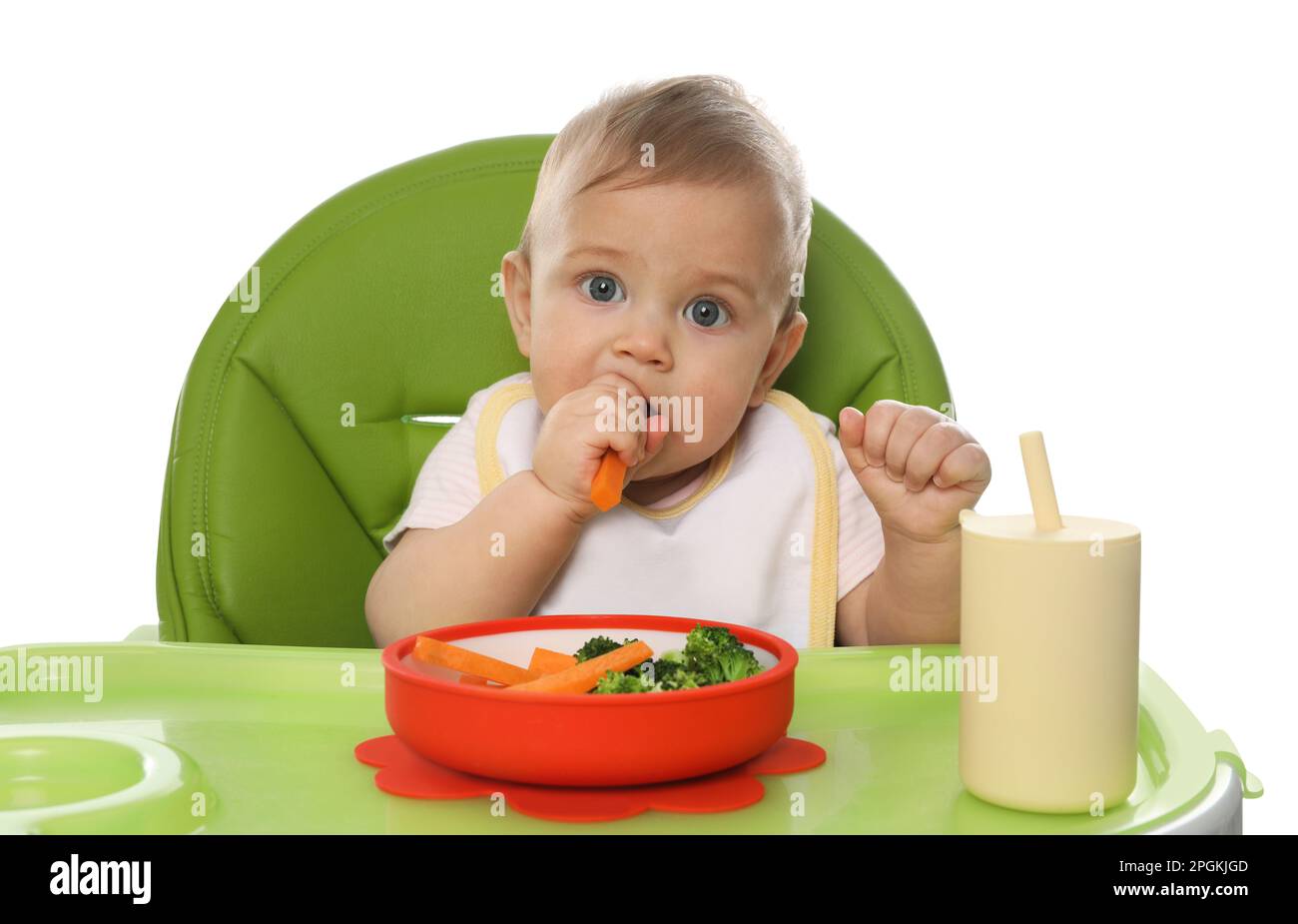 Cute little baby wearing bib while eating on white background Stock ...