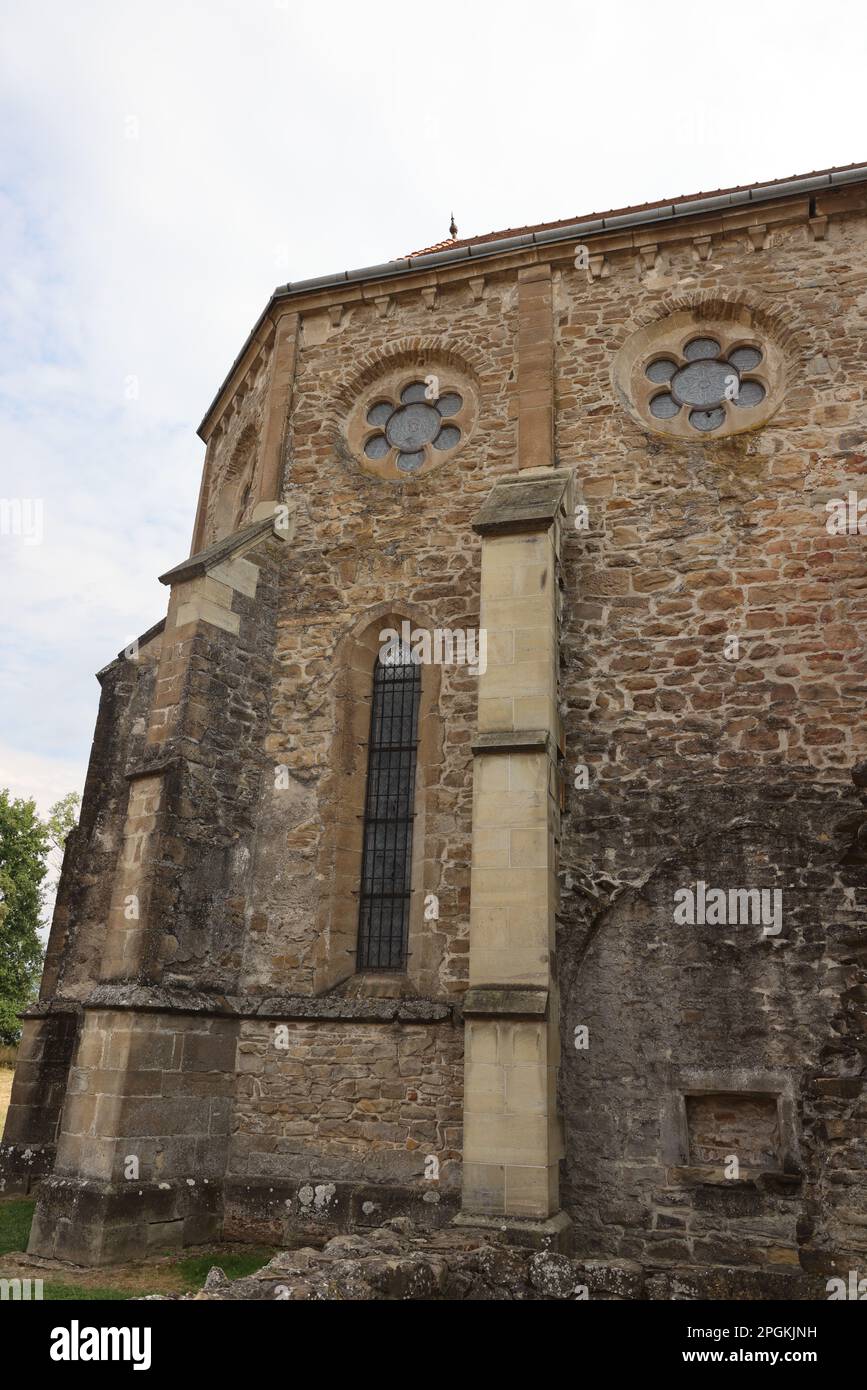 Outside view of round stained-glass windows in the church of Cârța ...