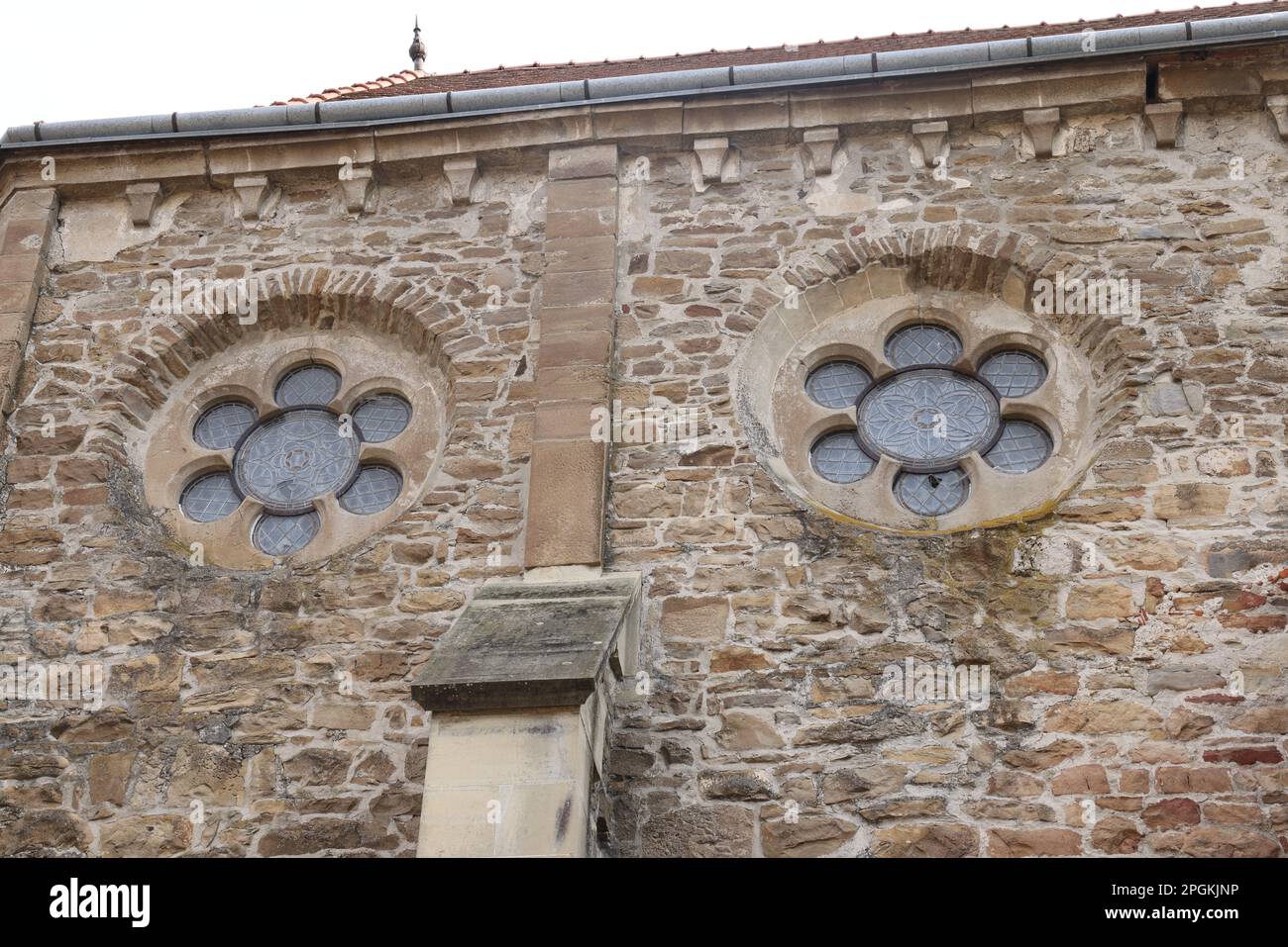 Outside view of round stained-glass windows in the church of Cârța ...