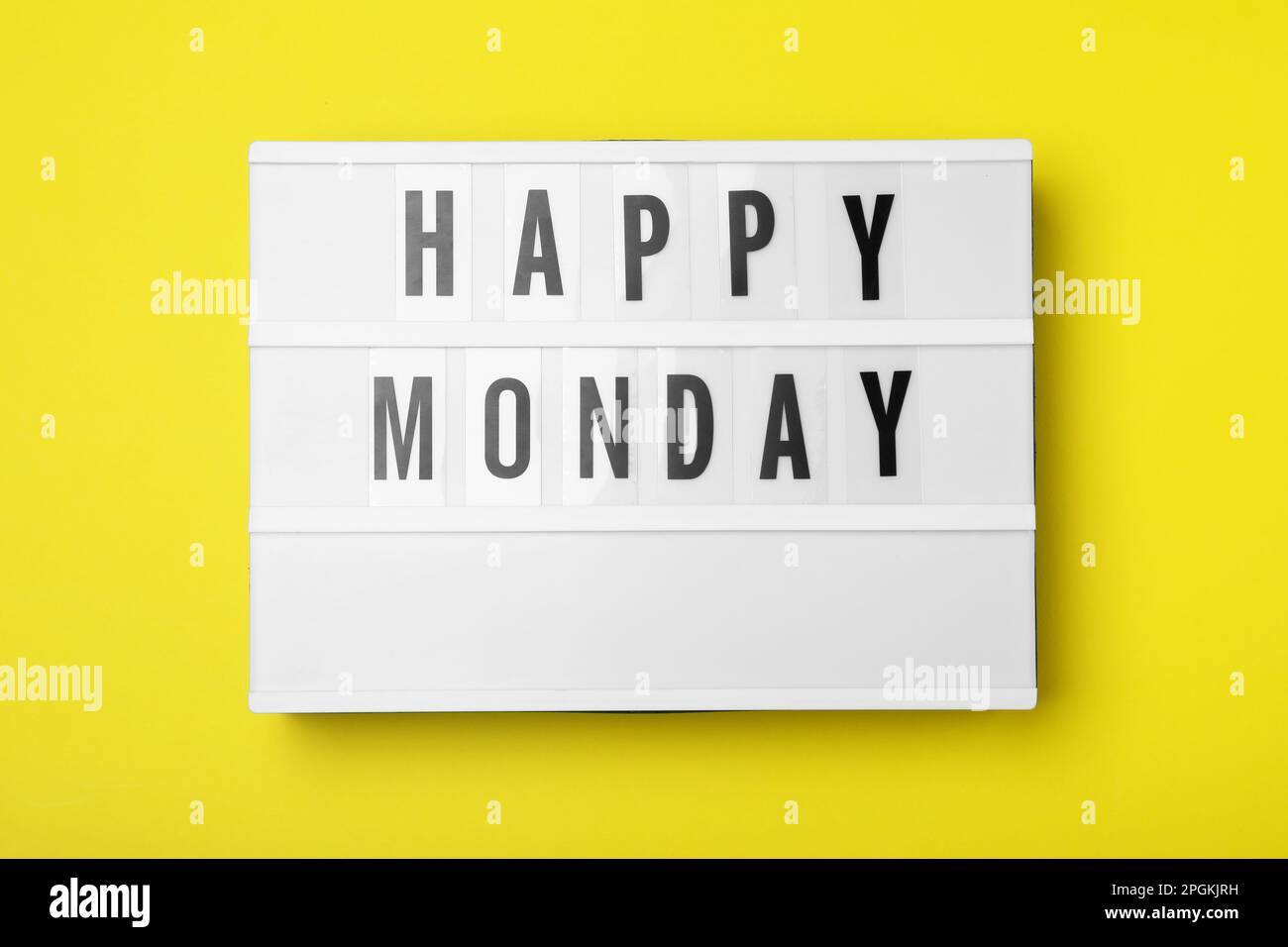 Light box with message Happy Monday on yellow background, top view ...