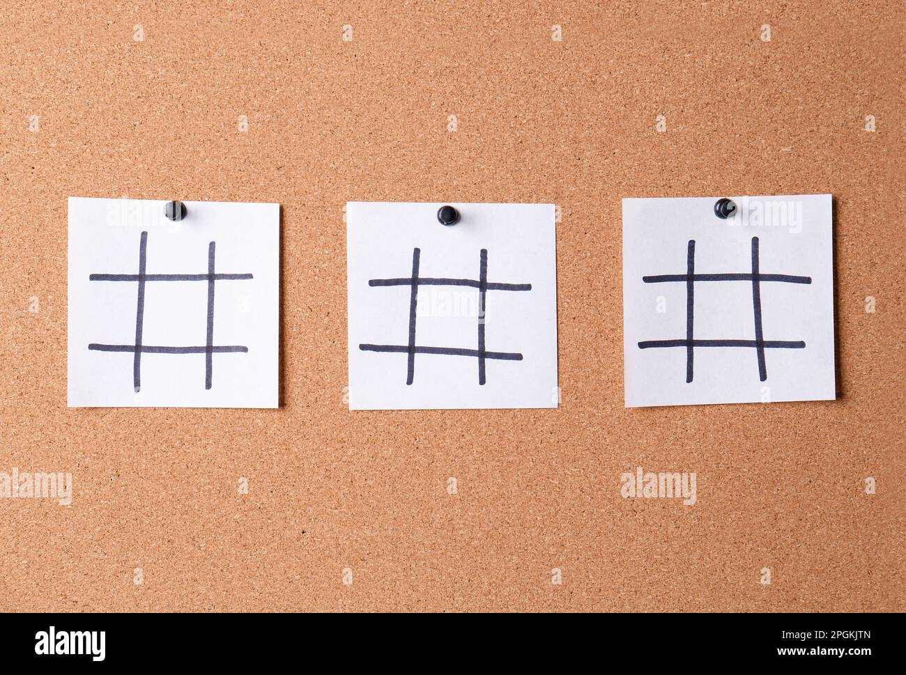 White note papers with hashtag symbols pinned on corkboard Stock Photo ...