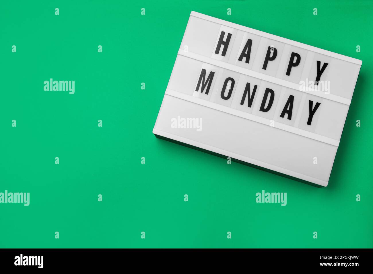 Light box with message Happy Monday on green background, top view ...