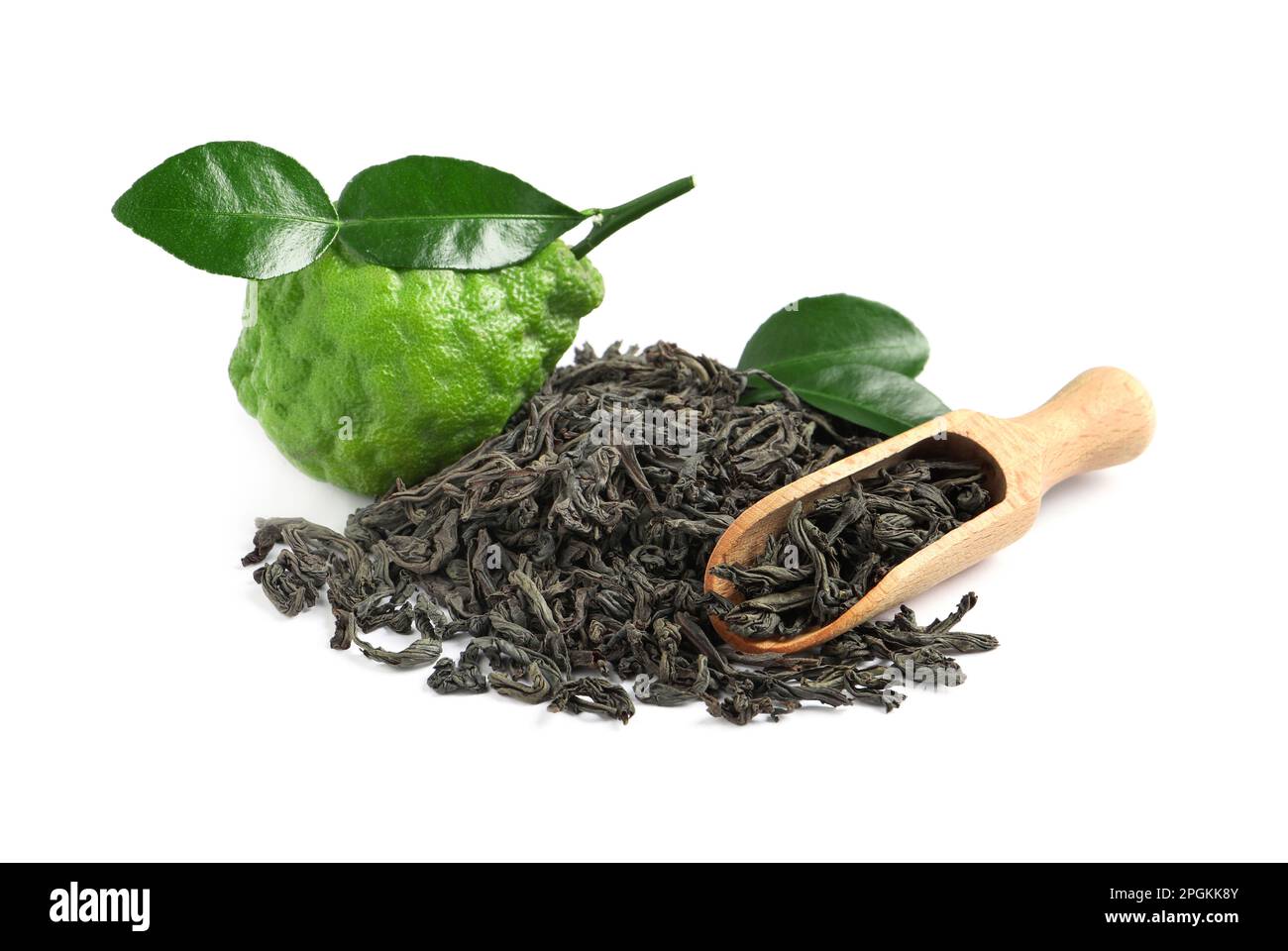 Dry bergamot tea leaves, wooden scoop and fresh fruit on white ...