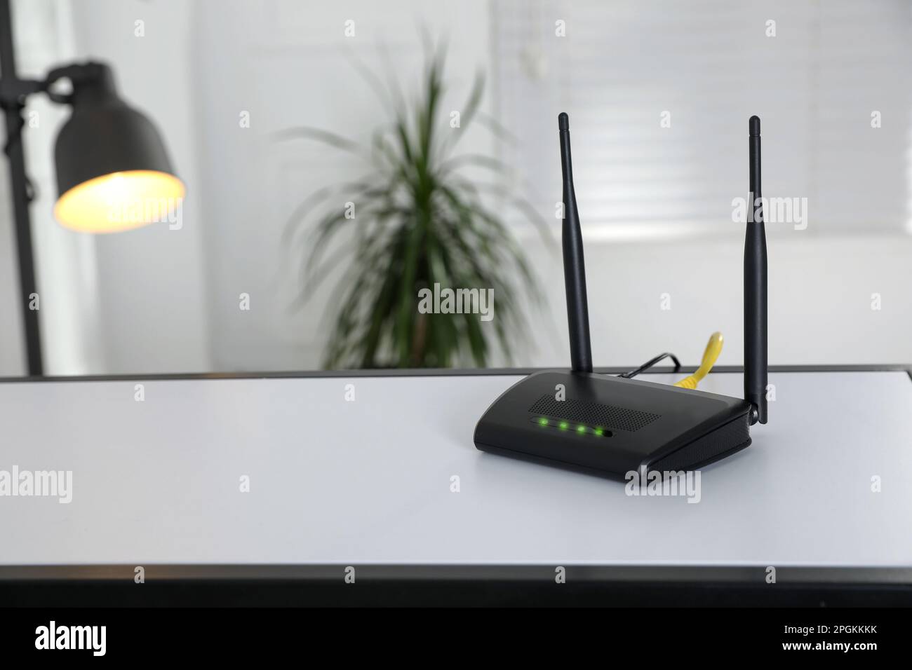 Modern Wi-Fi router on table indoors. Space for text Stock Photo - Alamy