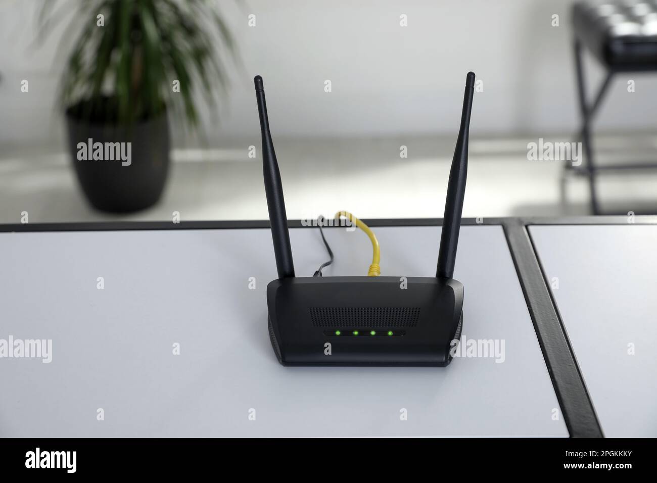 Modern Wi-Fi router on white table indoors Stock Photo - Alamy