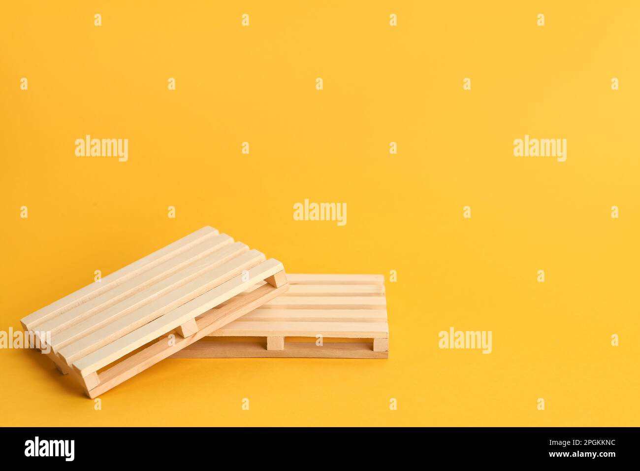 Wooden pallets on orange background, space for text Stock Photo - Alamy