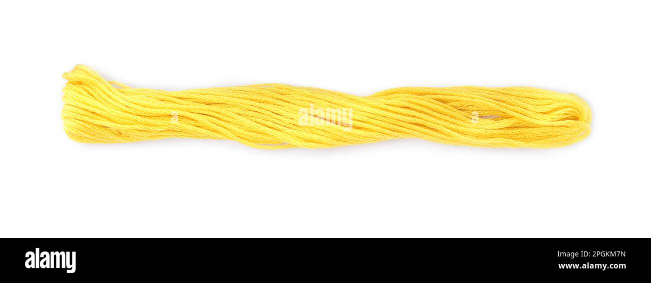 Bright yellow embroidery thread on white background Stock Photo - Alamy