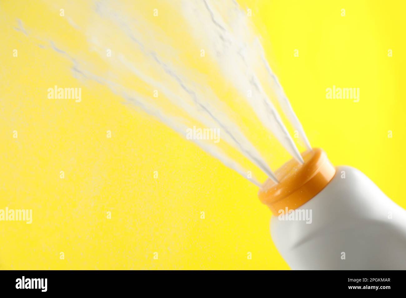 Scattering of dusting powder on yellow background Stock Photo - Alamy