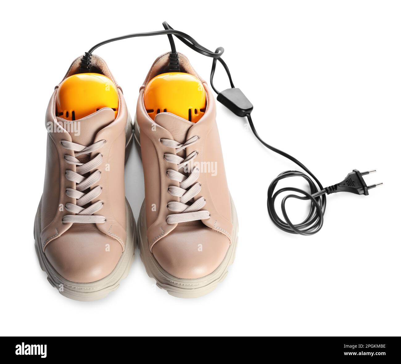 Pair of stylish shoes with modern electric footwear dryer on white ...