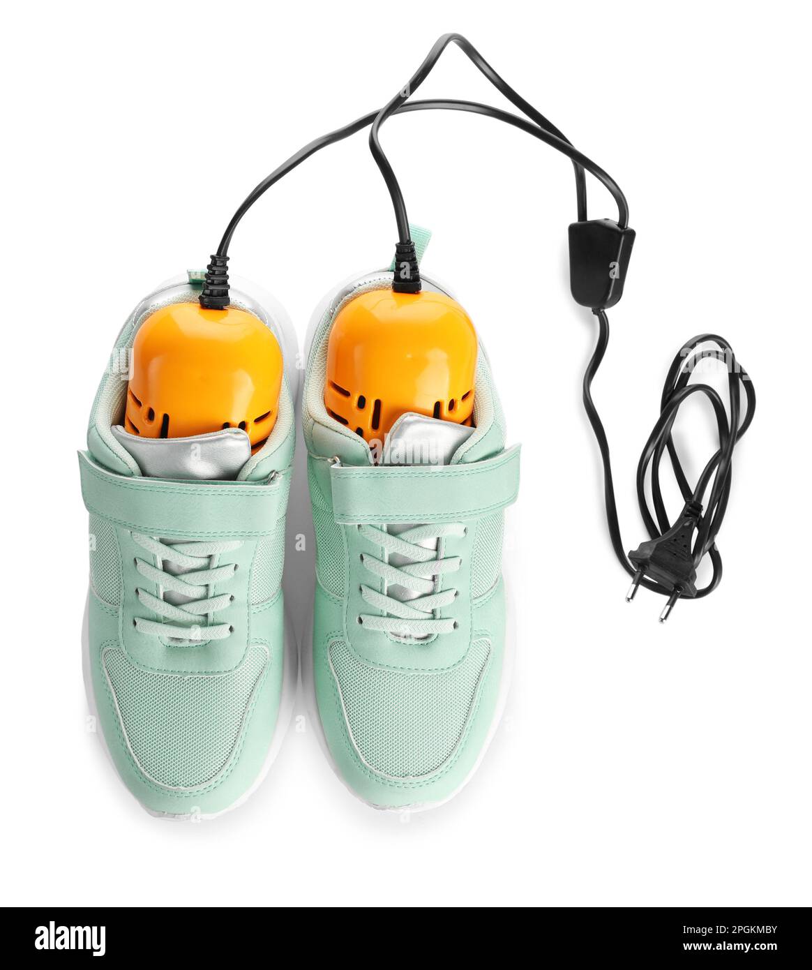 Pair of stylish sneakers with modern electric shoe dryer on white ...