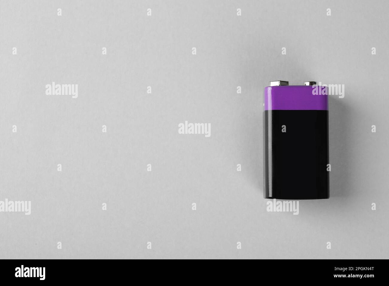 New nine volt battery on light grey background, top view. Space for ...