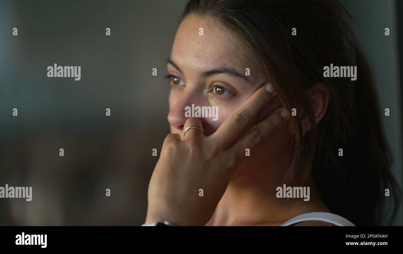 Contemplative woman thinking deeply at apartment balcony. Pensive ...
