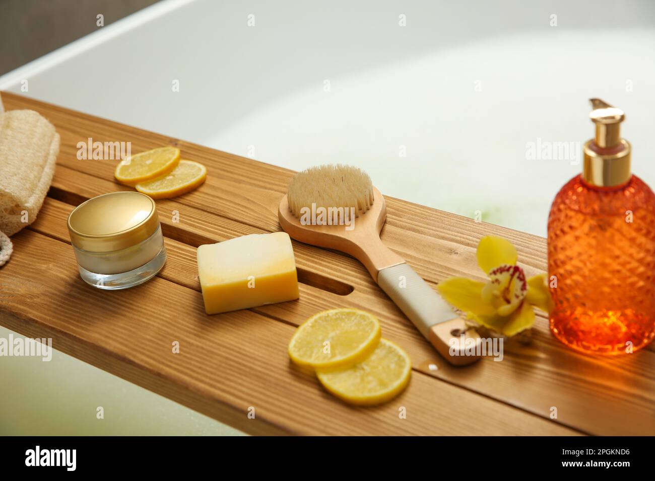 Wooden bath tray with bathroom amenities on tub, closeup Stock Photo ...