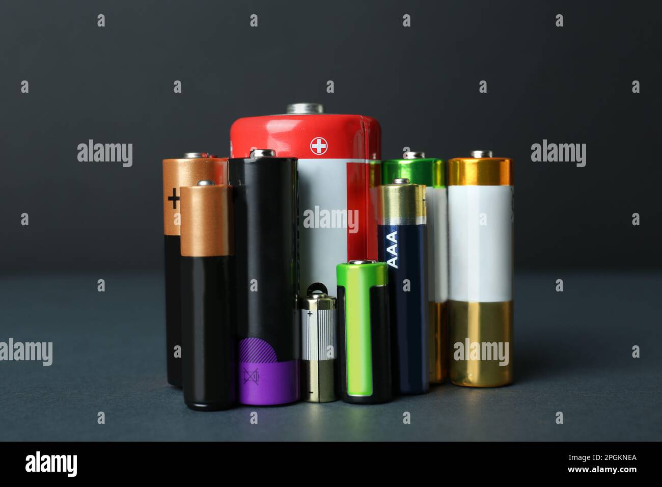 Different types of batteries on dark background Stock Photo - Alamy