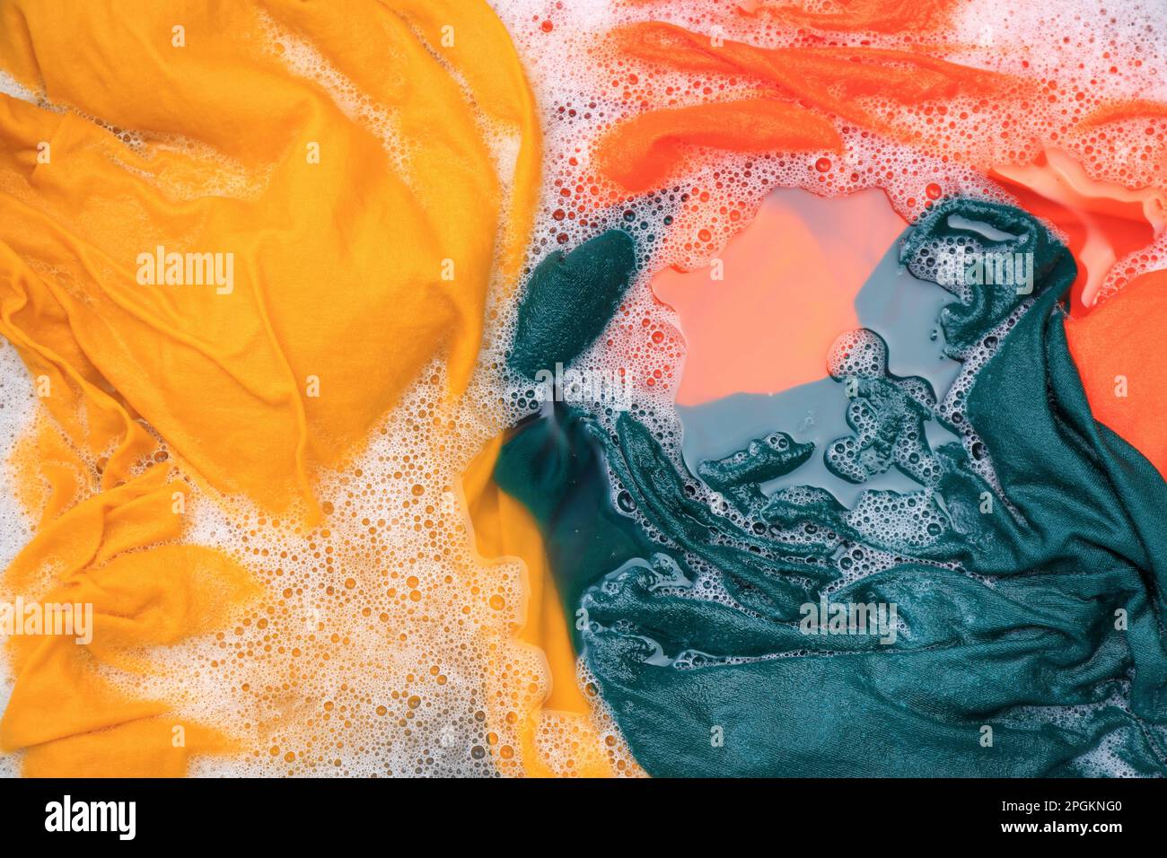 Colorful clothes in suds, top view. Hand washing laundry Stock Photo ...