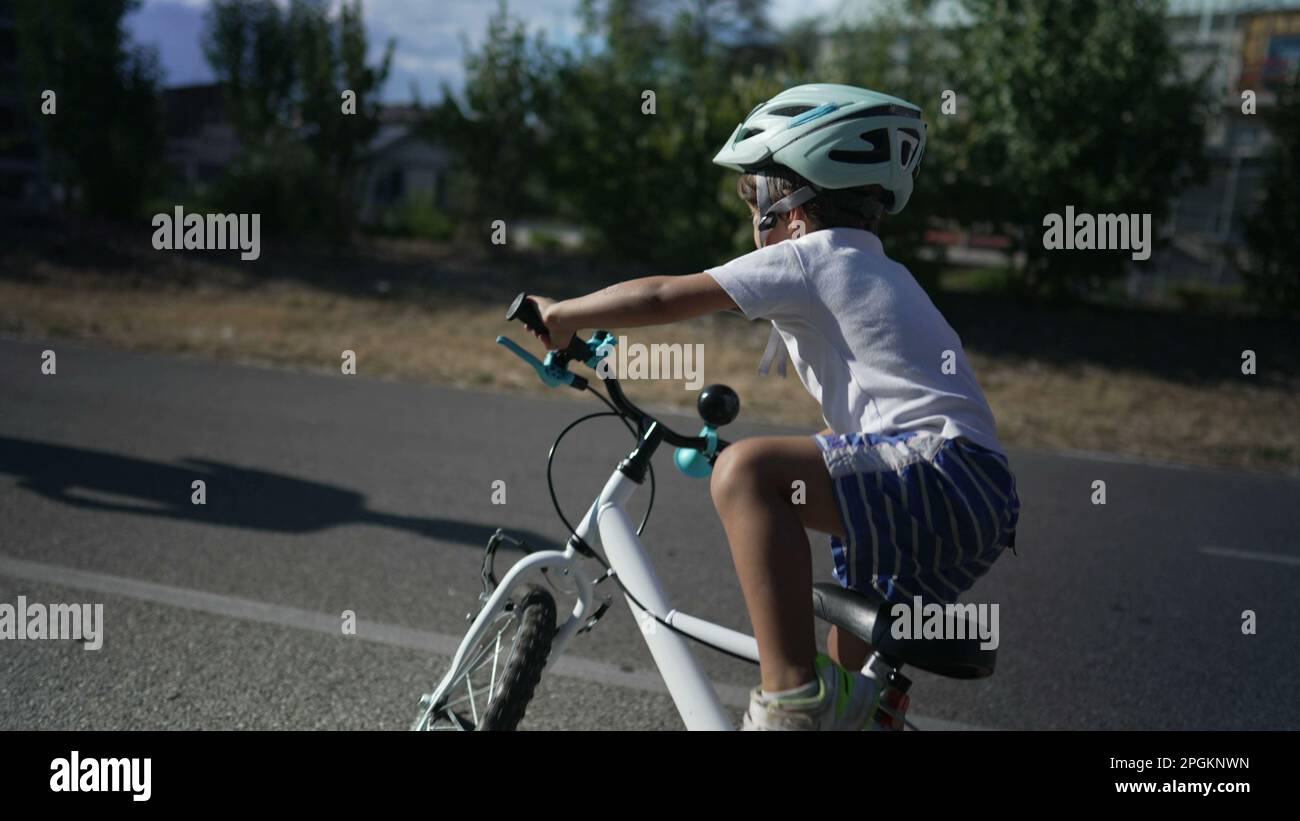 Child falling from bicycle while learning to ride. Small boy falls from ...