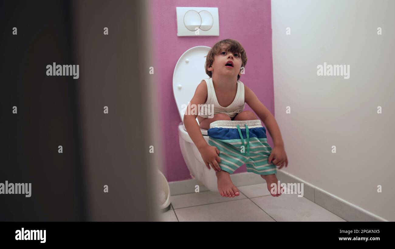 Child seated on toilet doing his needs Stock Photo - Alamy