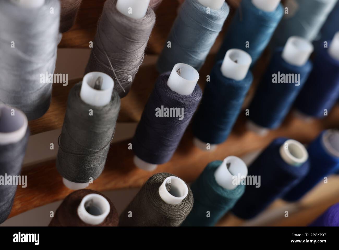 Set of colorful threads on stand, closeup. Tailoring accessories Stock ...