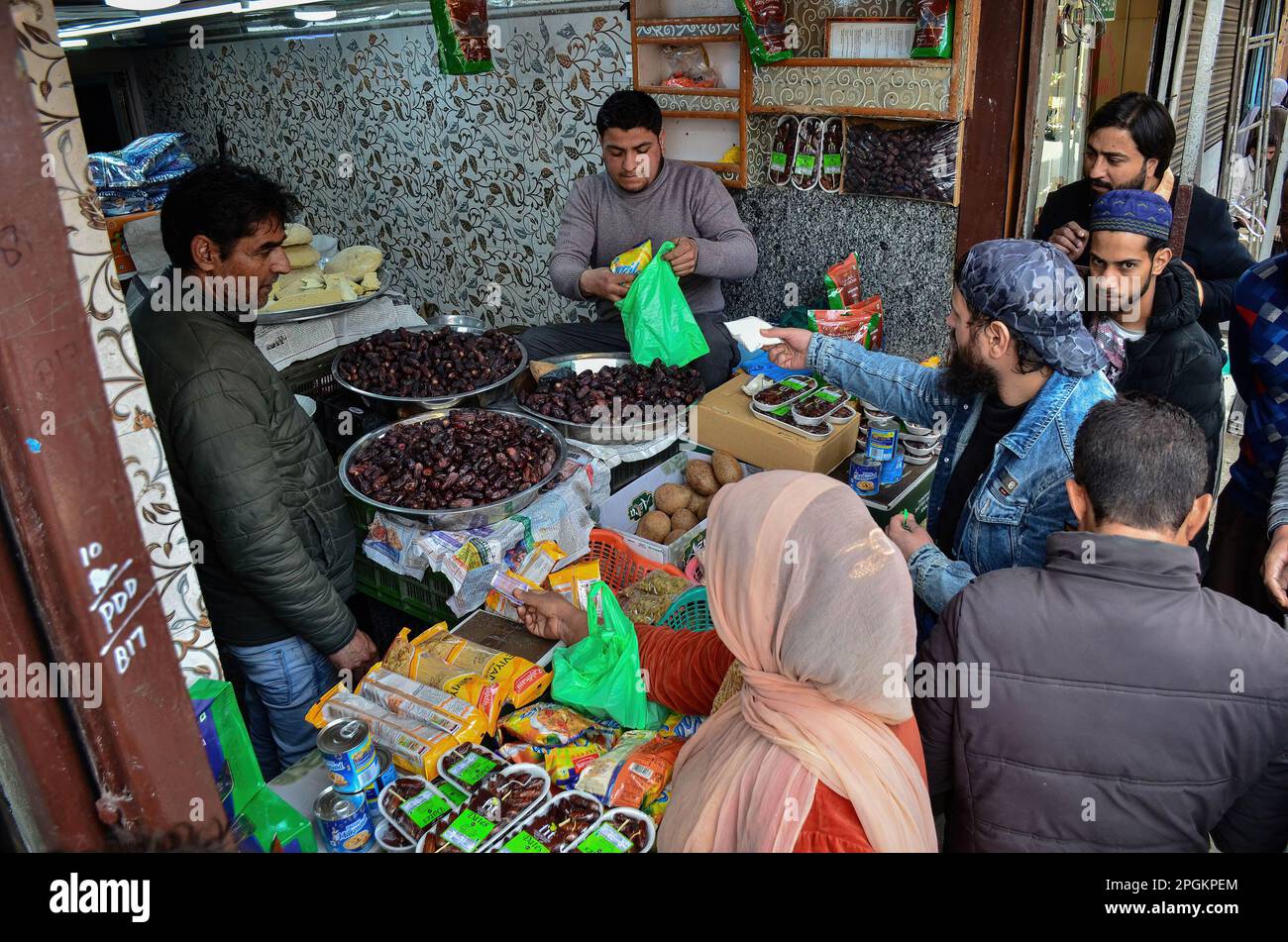 Srinagar, India. 23rd Mar, 2023. A roadside vendor sells dates and ...