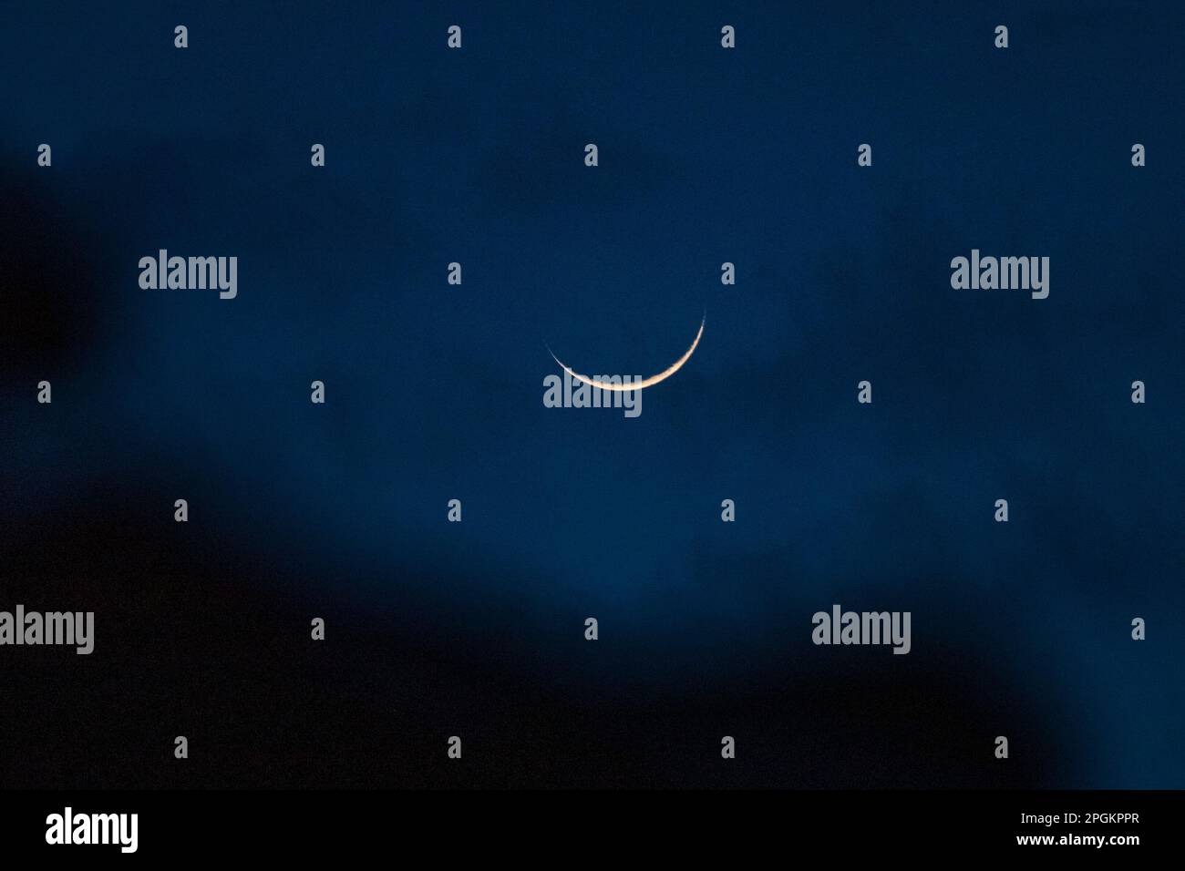 The crescent moon or Ramadan moon rises over the sky on the first day ...